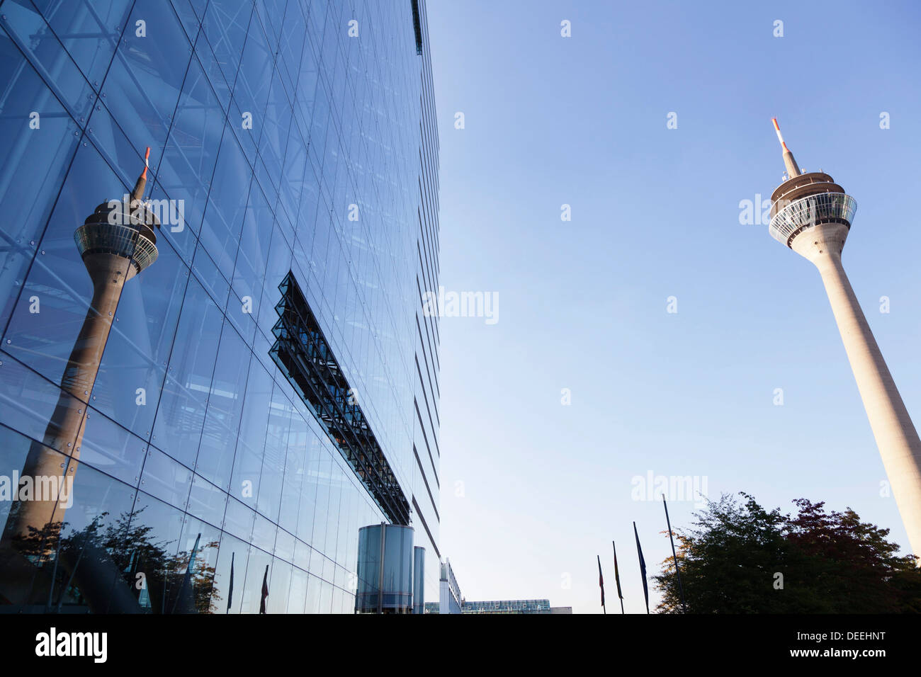 Rheinturm tower reflecting in the facade of Stadttor building ...