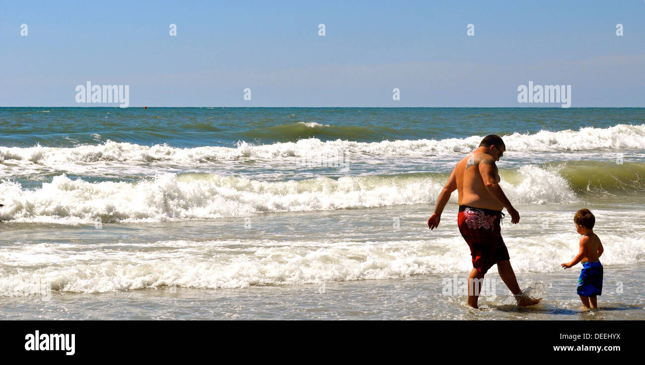 Father and Son Splash in the ocean Stock Photo - Alamy