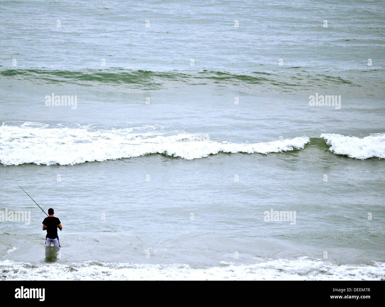 Fishing in the waves Stock Photo - Alamy