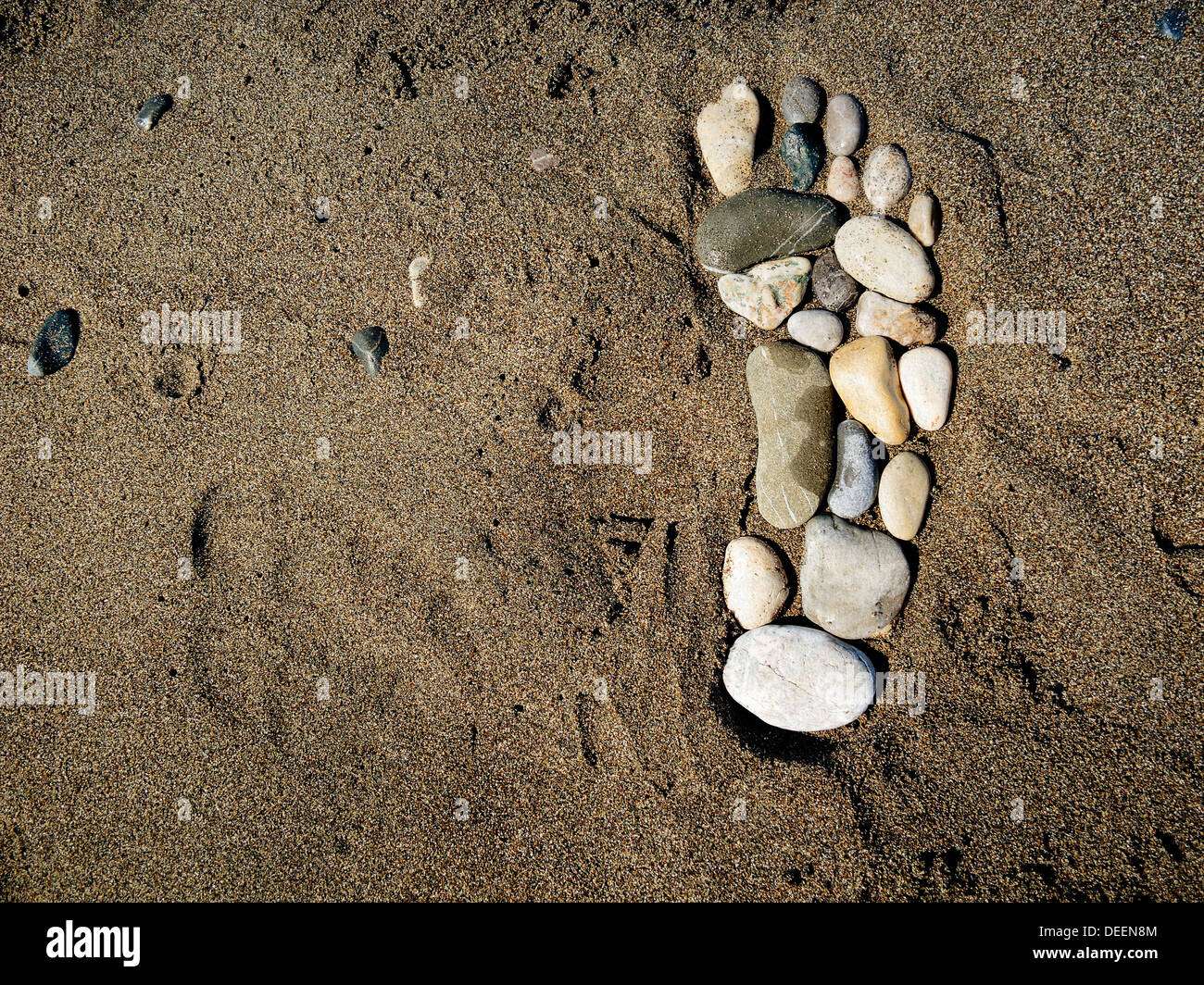 Single footprint made of stones Stock Photo - Alamy