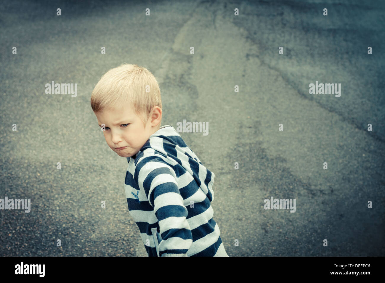 Boy (4-5) looking over shoulder, France Stock Photo - Alamy