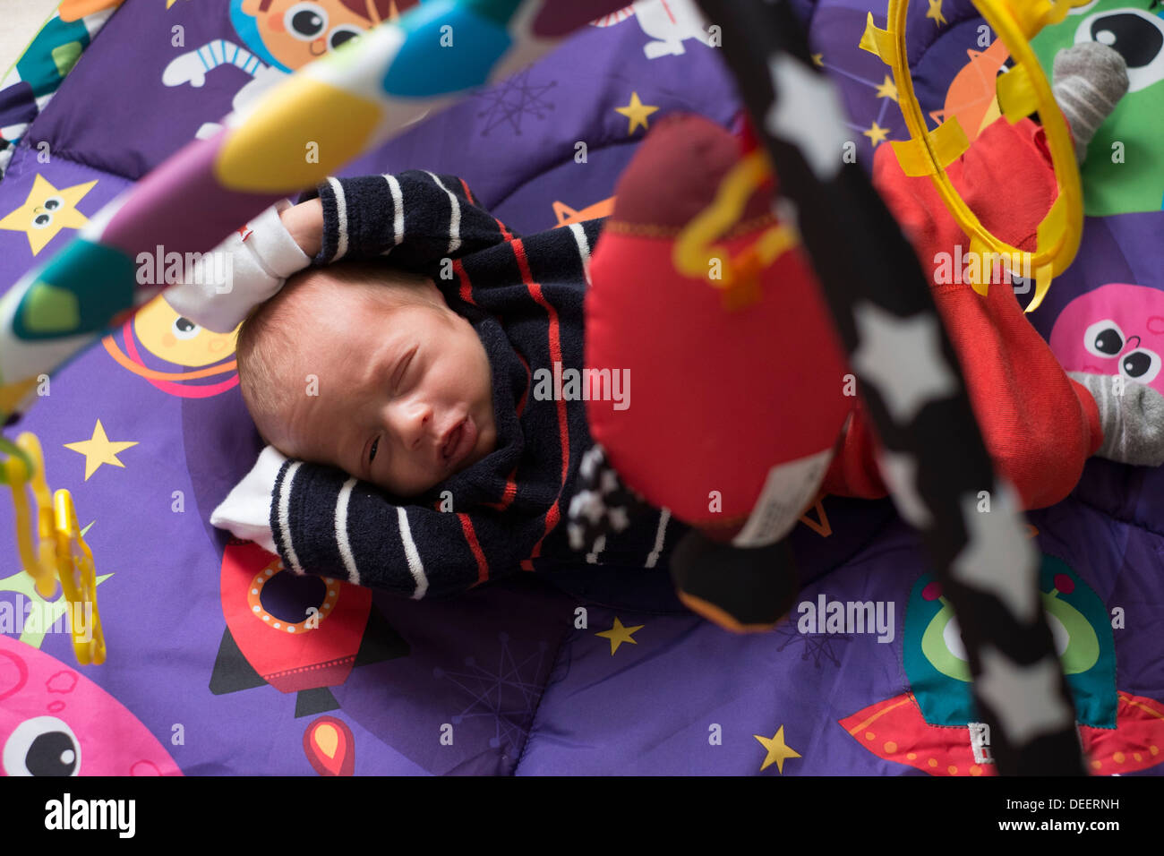 A newborn baby boy playing on his baby gym Stock Photo - Alamy