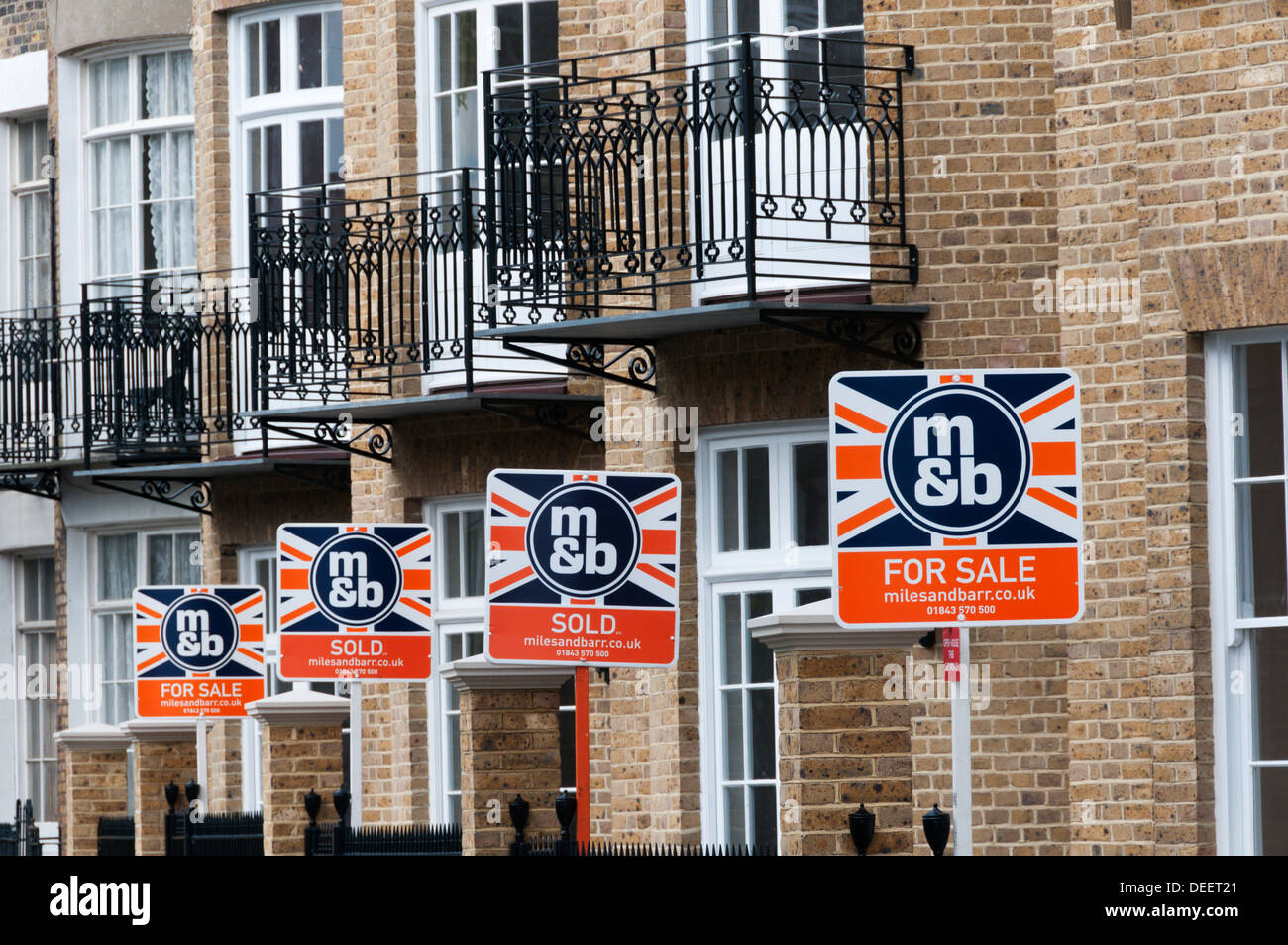 Estate agents For Sale and Sold signs on a row of modern terraced ...