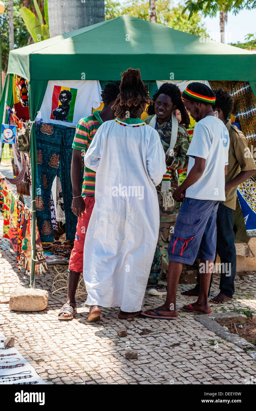 Africa, Angola, Benguela. Rastafarian men gathered outside streetside ...