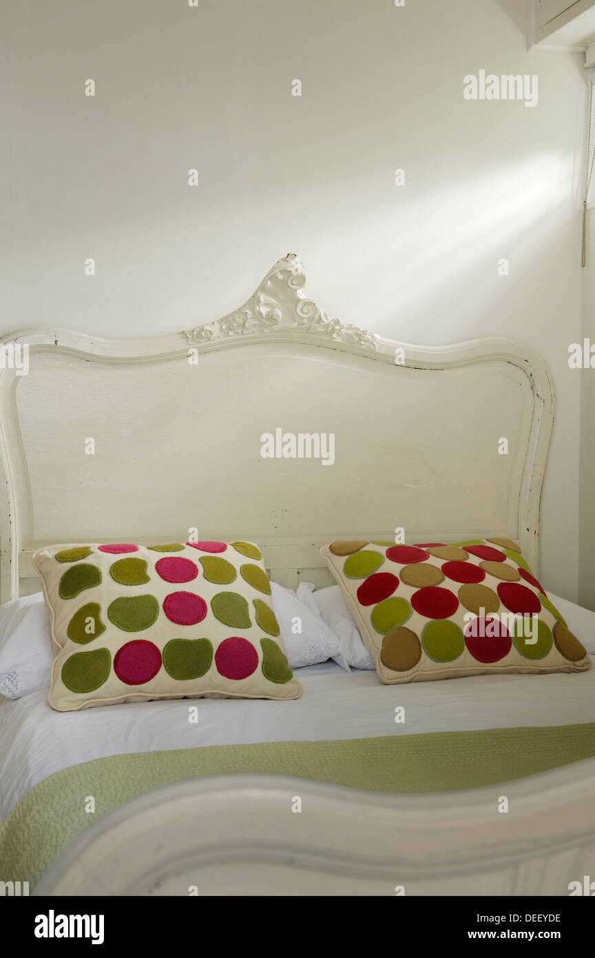 Spotted cushions on queen sized bed Stock Photo - Alamy