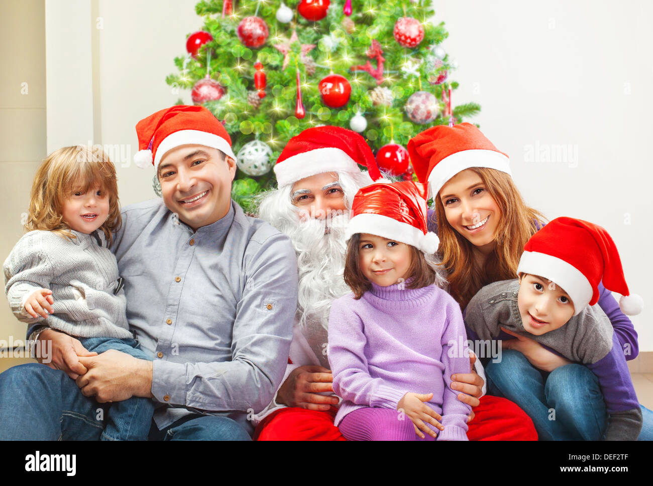 Large family and Santa Claus sitting near Christmas tree at home ...