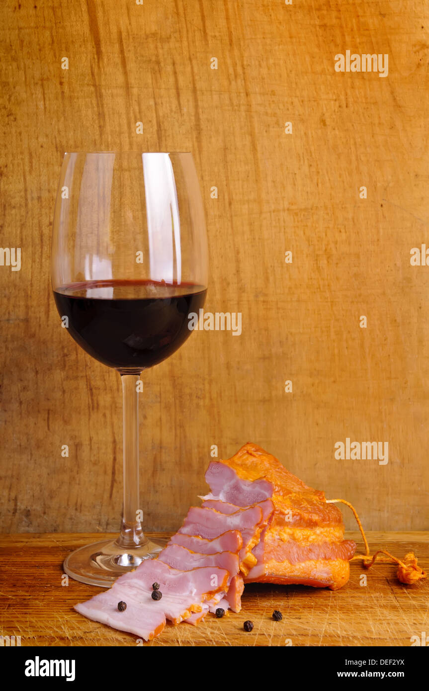 glass of red wine with smocked ham on a wooden background Stock Photo ...