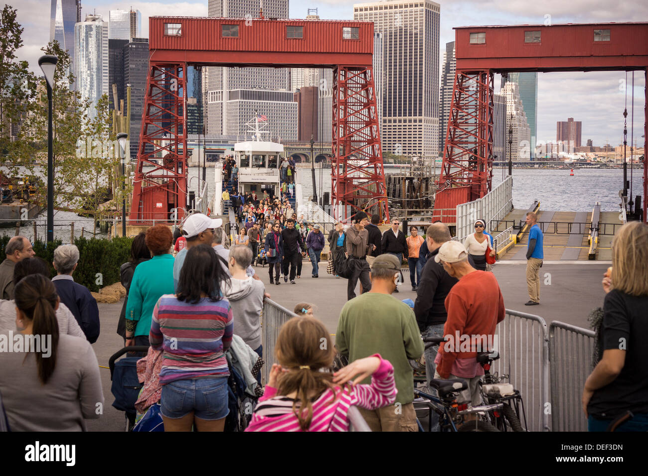Passengers disembark the ferry as others wait to board on Governor's ...