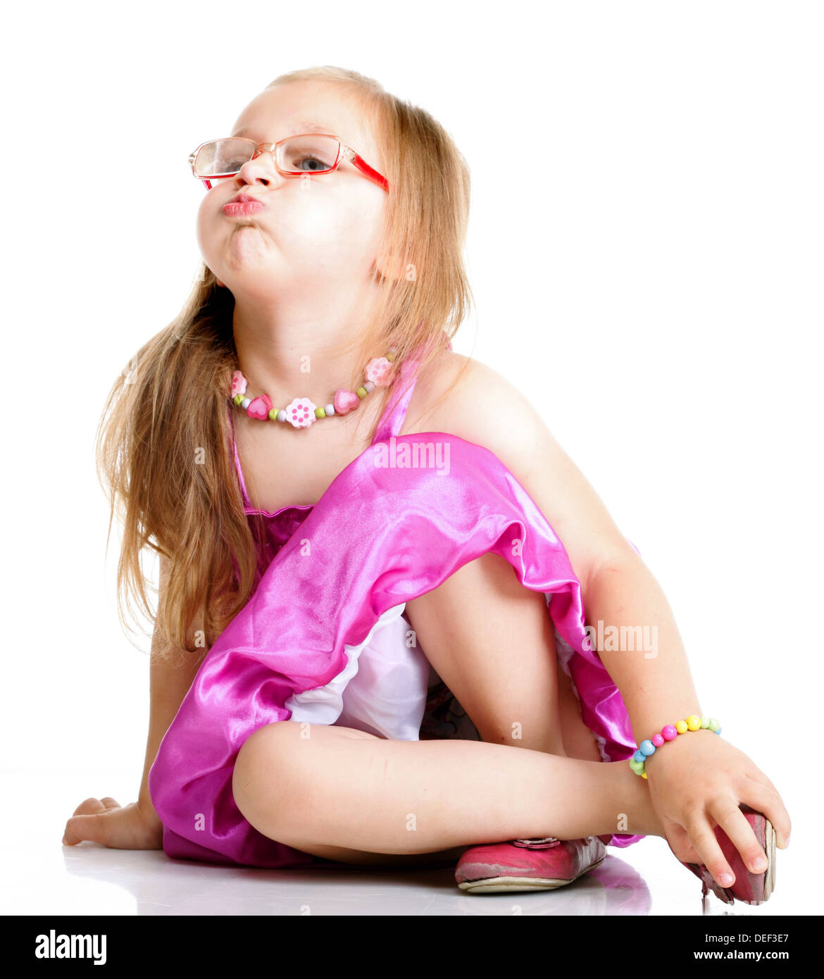 Full Lehgth A Cute Girl Sitting On Floor Puffs Up Her Cheeks On White