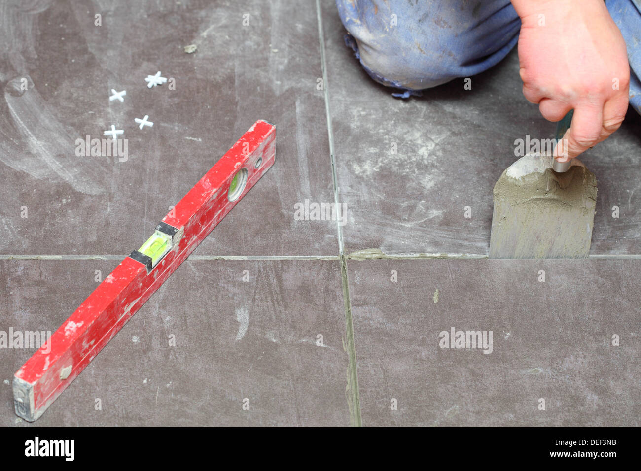 Worker with tool. Red balance spirit building level in construction ...