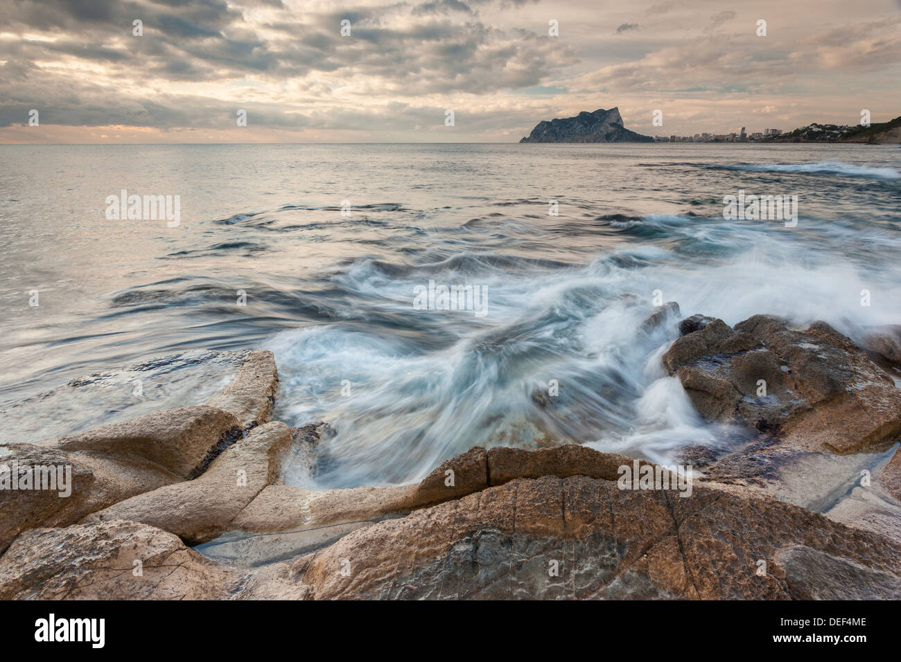 Sunrise with rocks and waves at cala baladrar in benissa with Peñón de ...