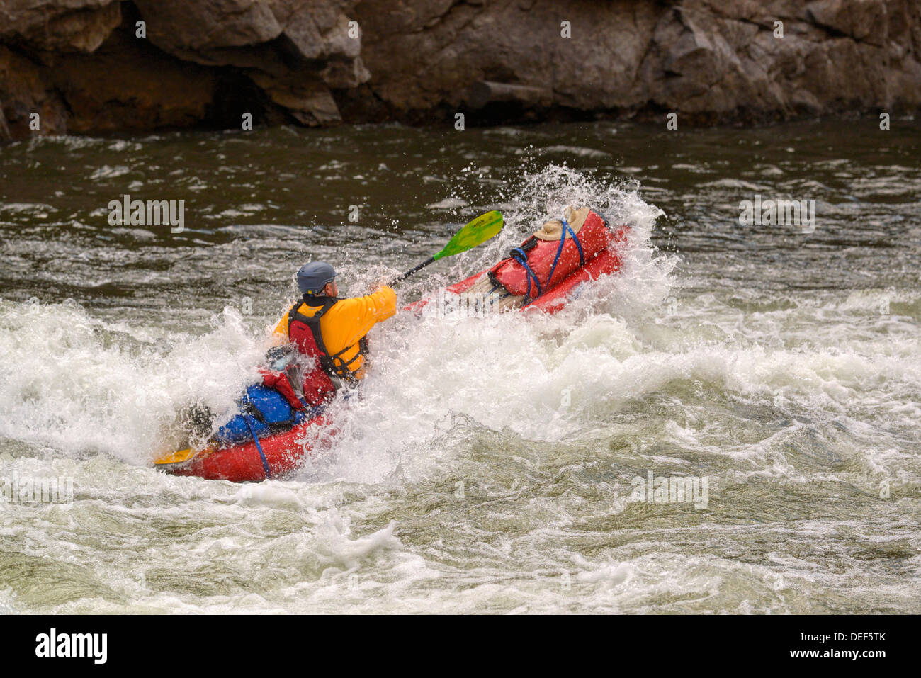 Paddling through a wave in an inflatable kayak on Idaho's Lower Salmon ...