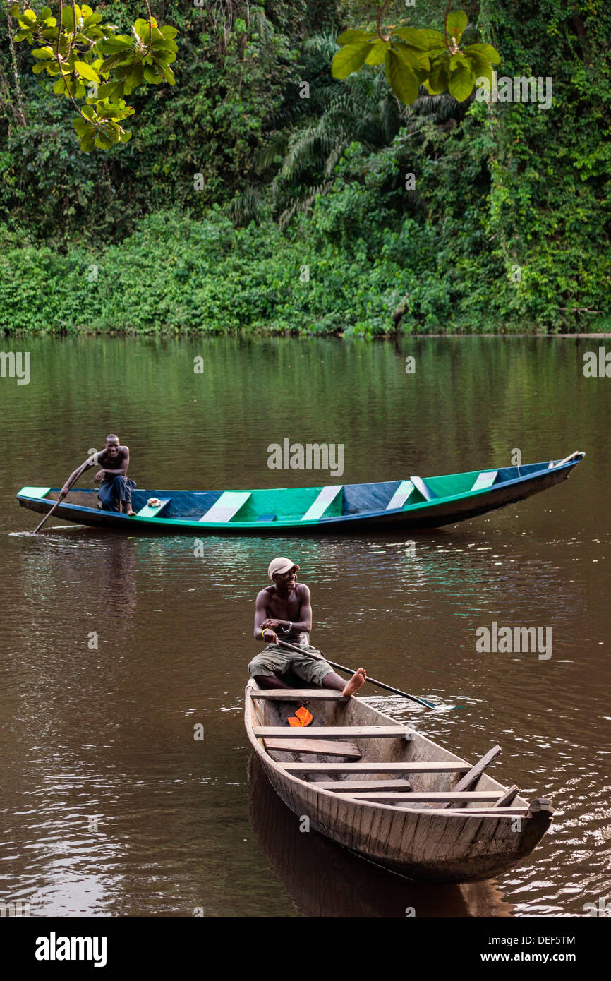 Africa, Cameroon, Kribi. Men in traditional pirogue fishing boats Stock ...