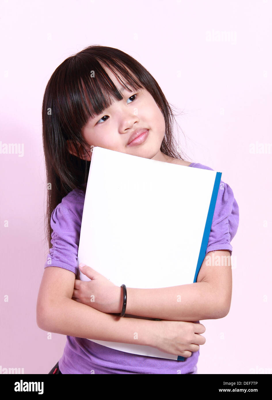 Kid holding a book hi-res stock photography and images - Alamy
