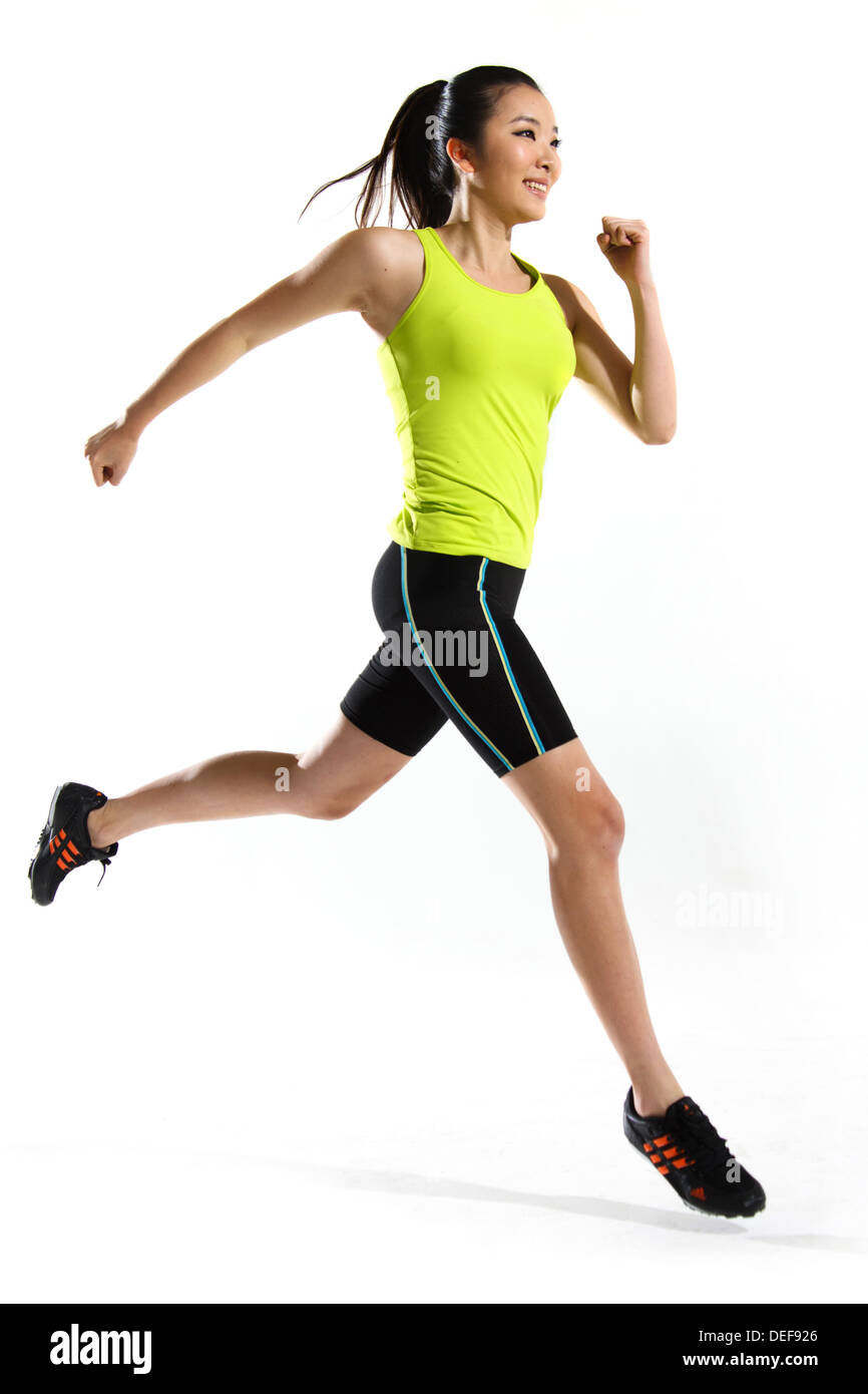Young woman jogging Stock Photo - Alamy