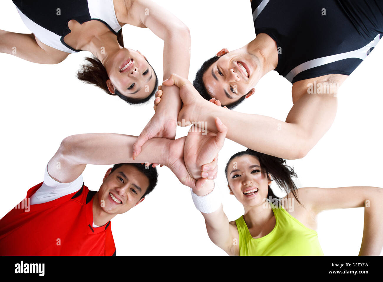 Low angle of group of athletes in huddle Stock Photo - Alamy