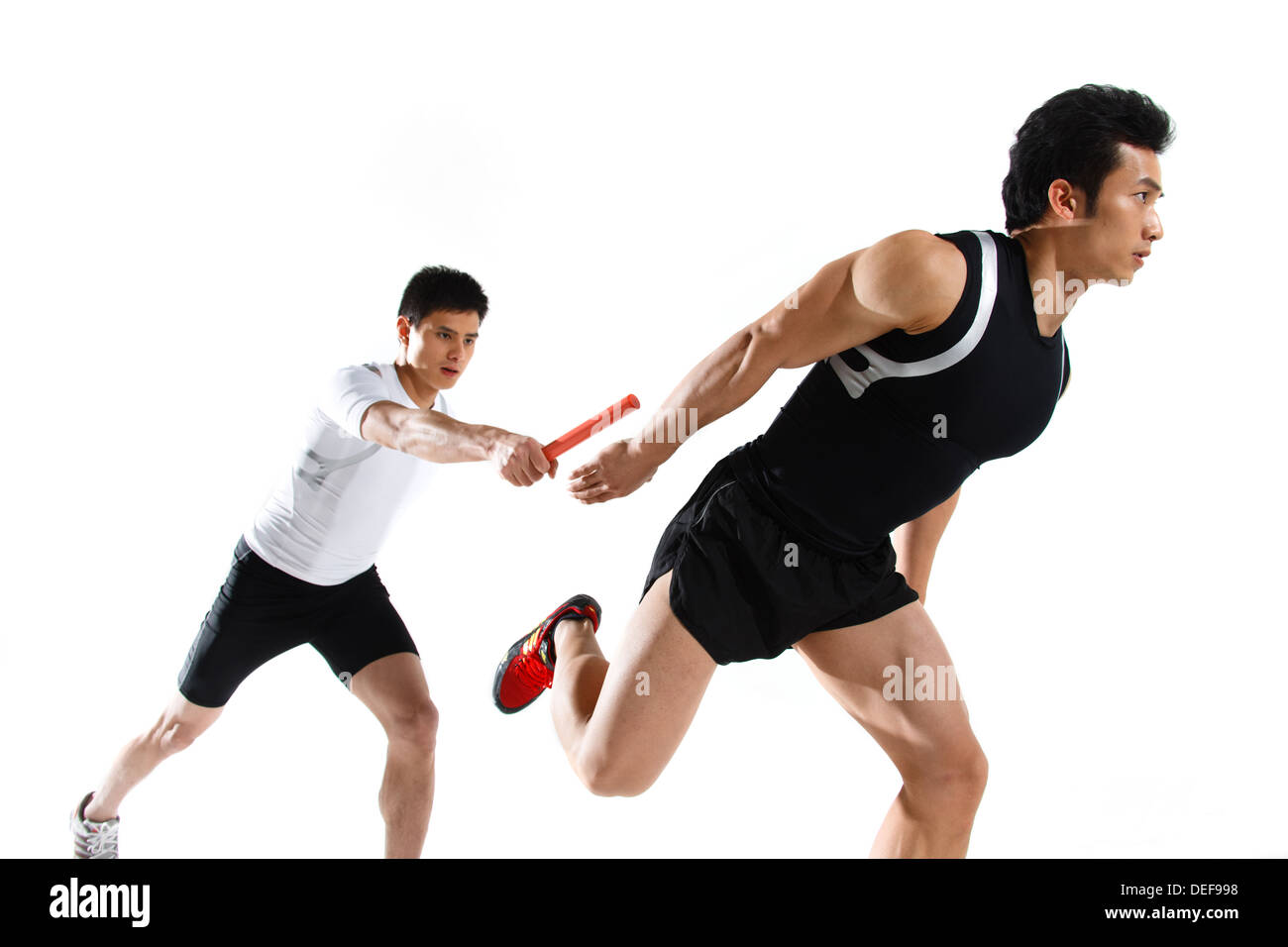Two men passing baton, close-up Stock Photo - Alamy