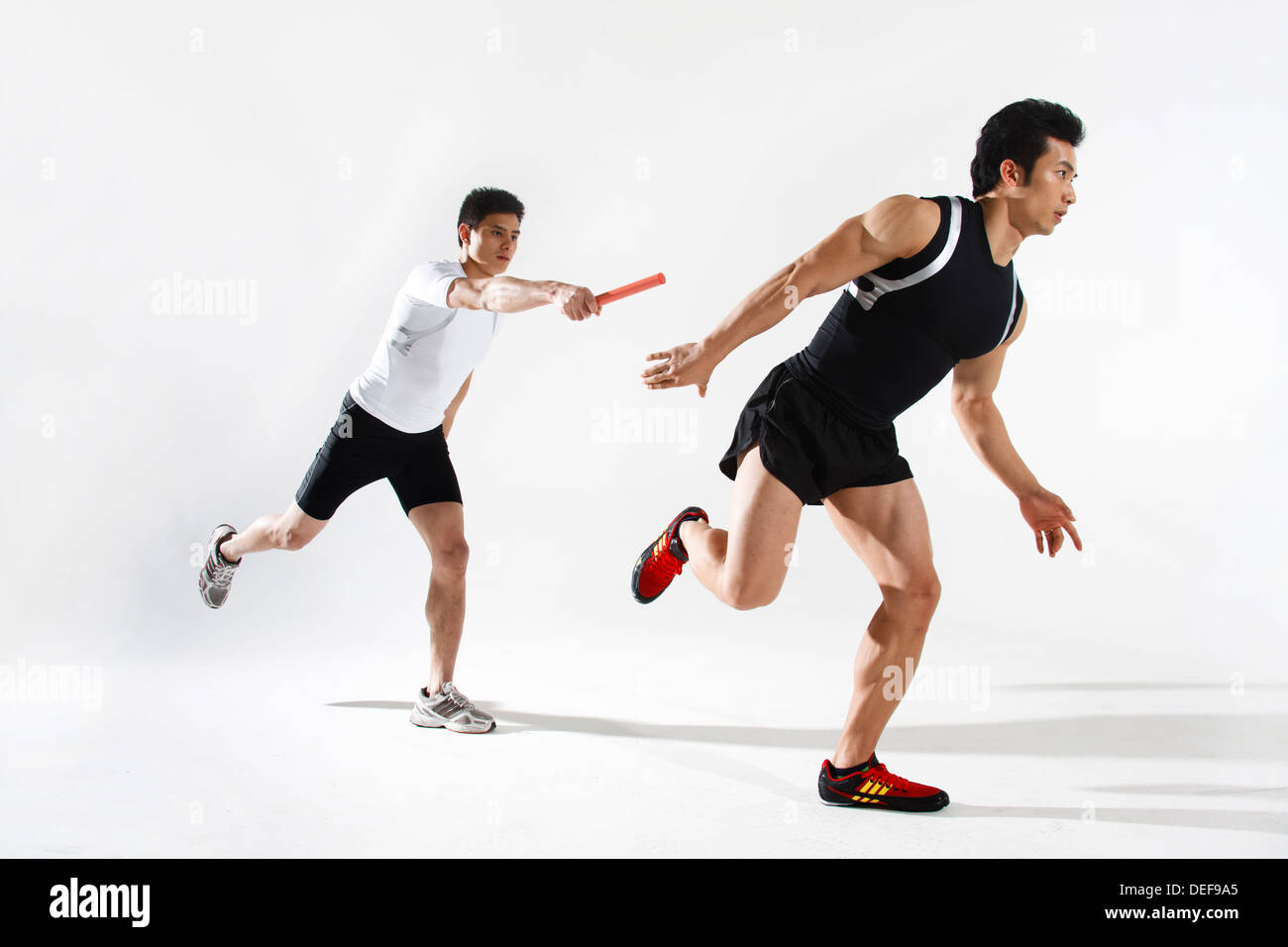 Relay baton passing men hi-res stock photography and images - Alamy