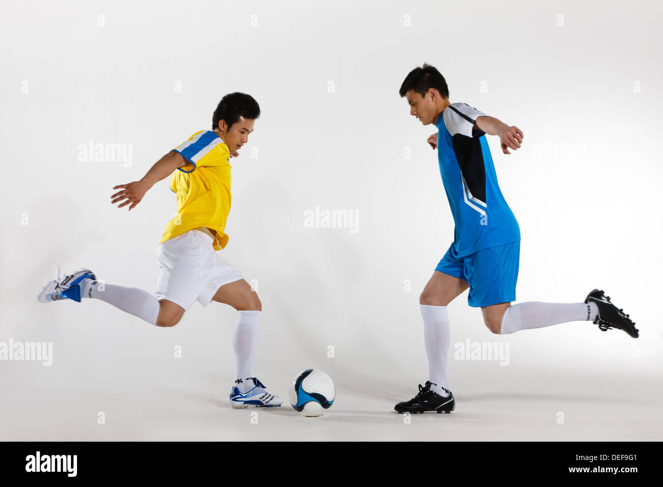 Two young men playing football Stock Photo - Alamy