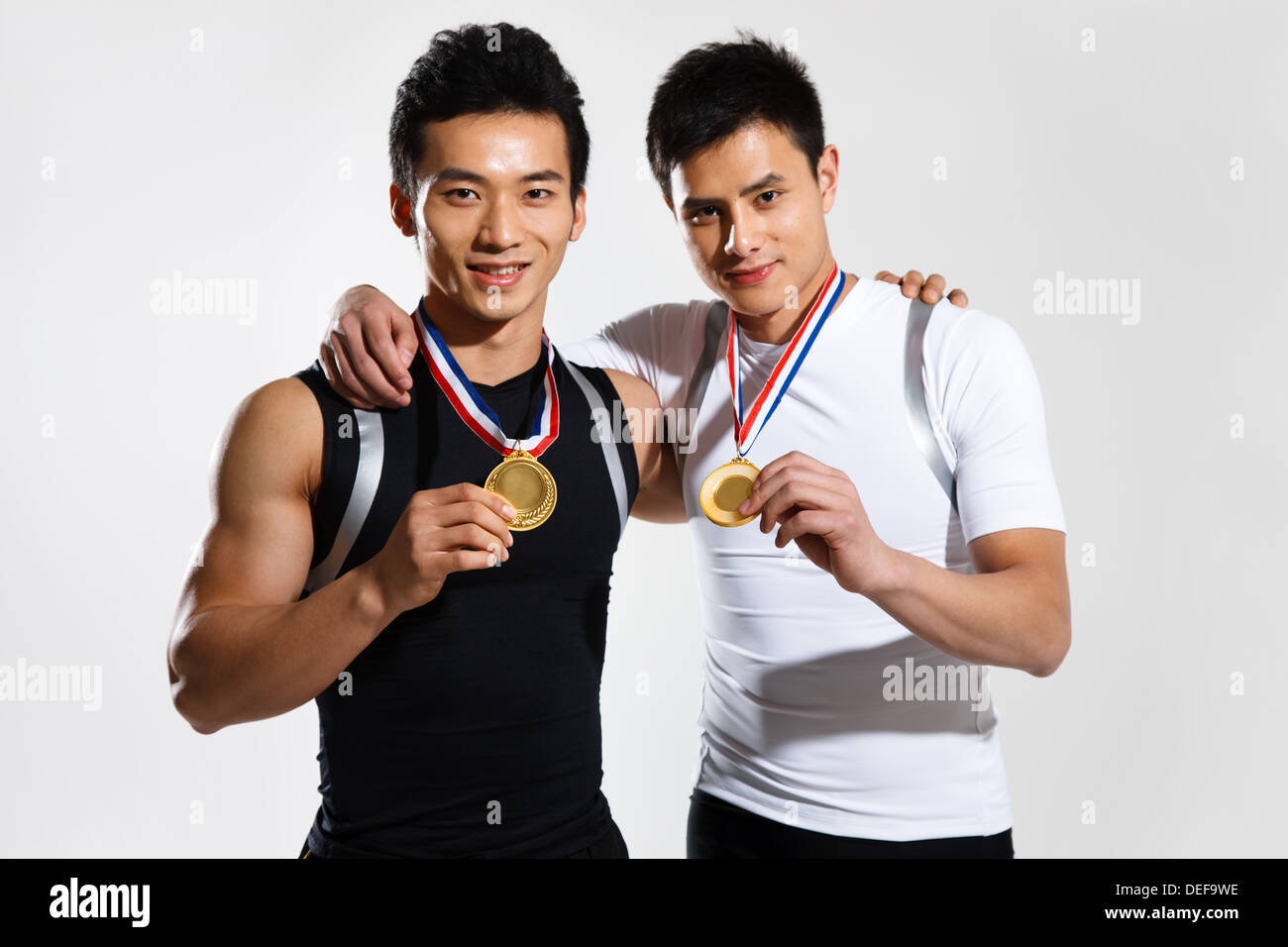 Two athletes wearing medals Stock Photo - Alamy