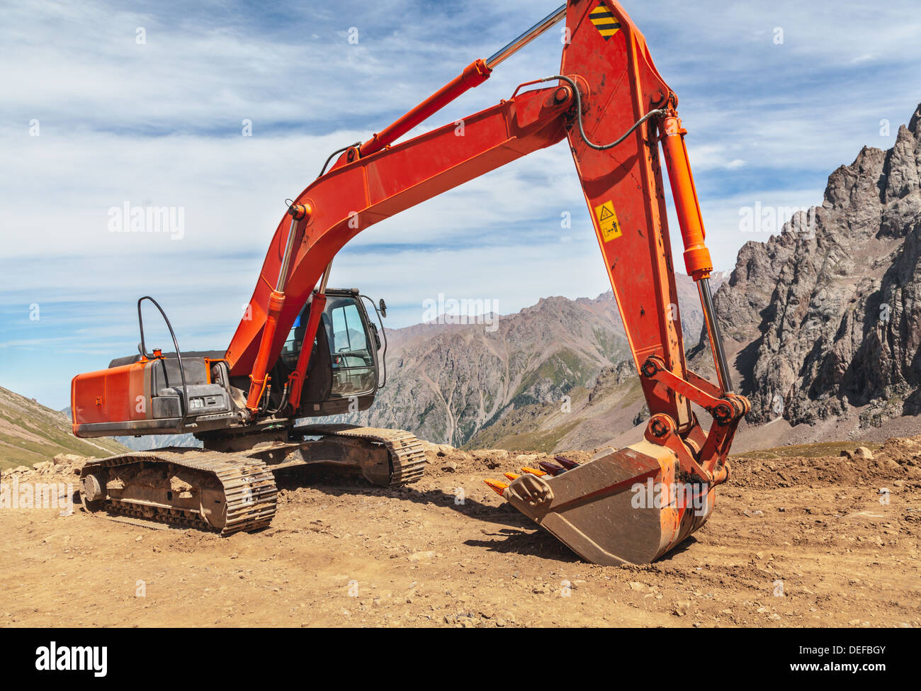 excavator mountain construction Stock Photo - Alamy