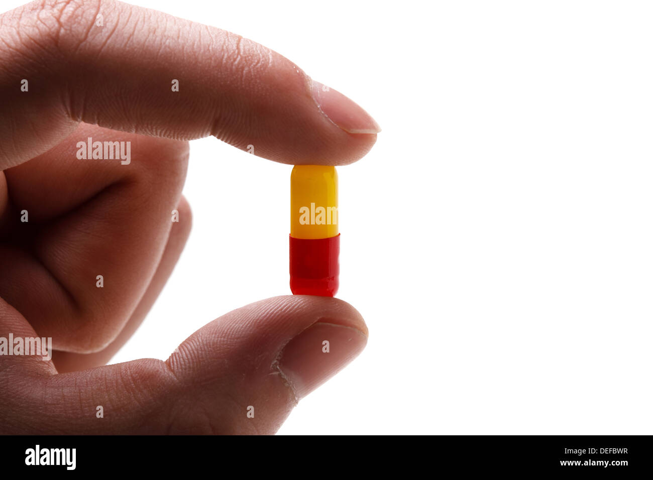 Hand holding a capsule Stock Photo - Alamy