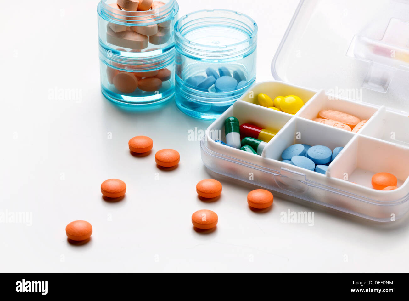 Assorted pills with pillbox Stock Photo - Alamy