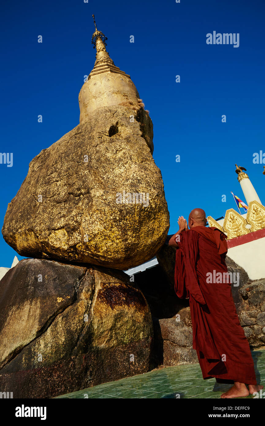 Buddhist monk praying at the Golden Rock of Nwa La Bo, Mawlamyine ...