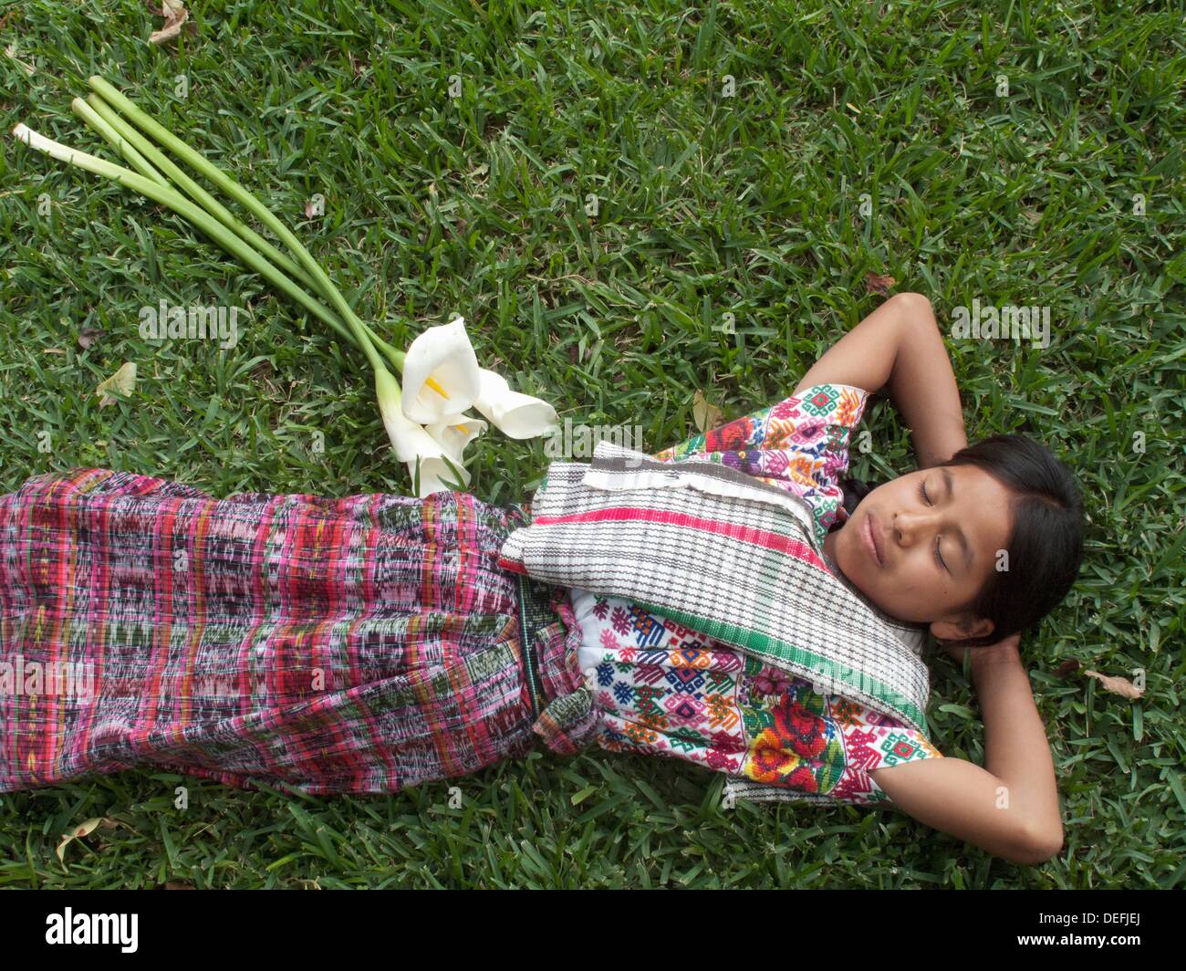 Young Maya girl resting on lawn Stock Photo - Alamy