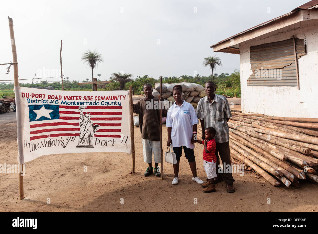 Africa, Liberia, Monrovia. Group beside sign for Du-Port Stock Photo ...