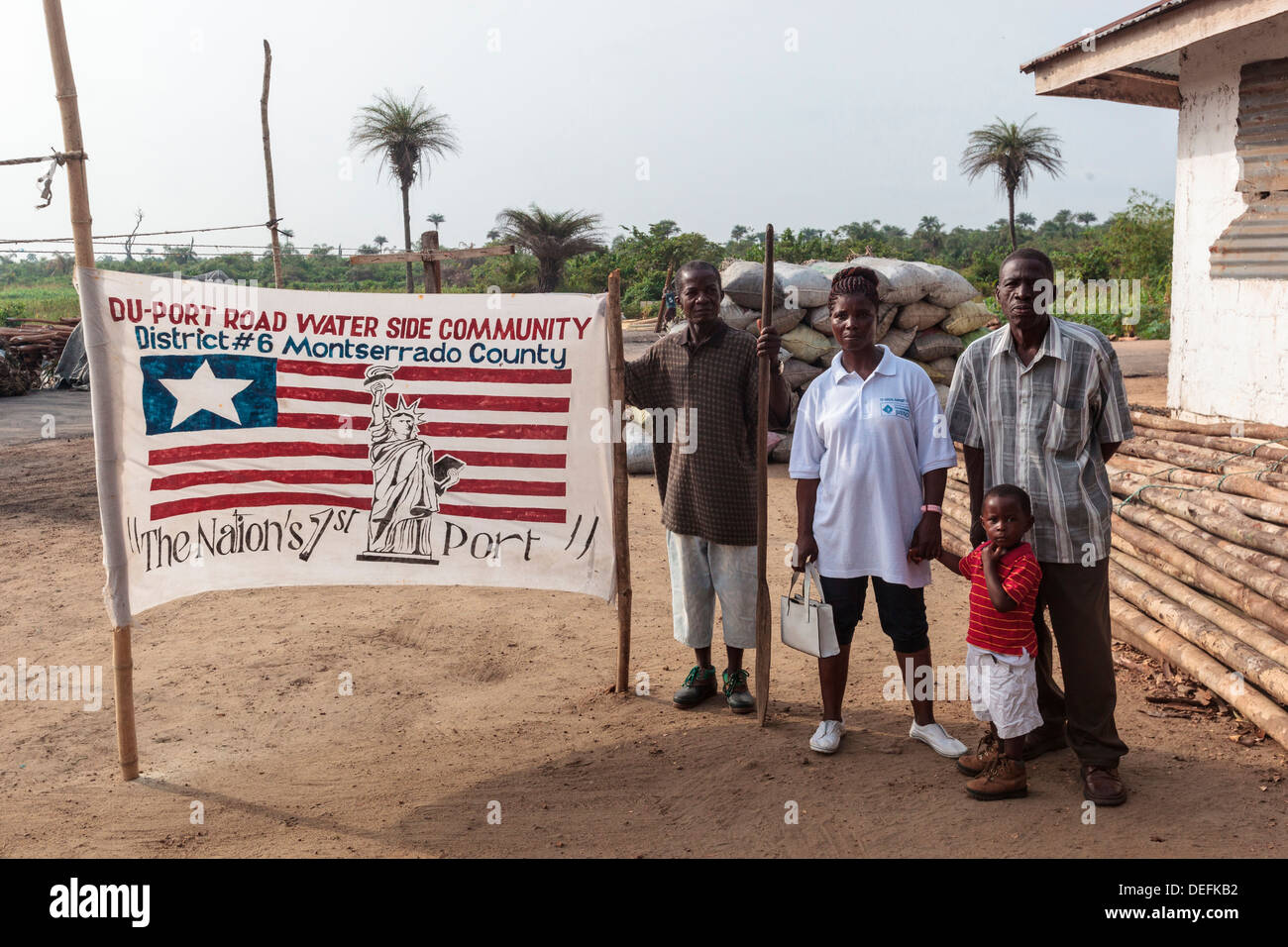 Africa, Liberia, Monrovia. Group beside sign for Du-Port Stock Photo ...