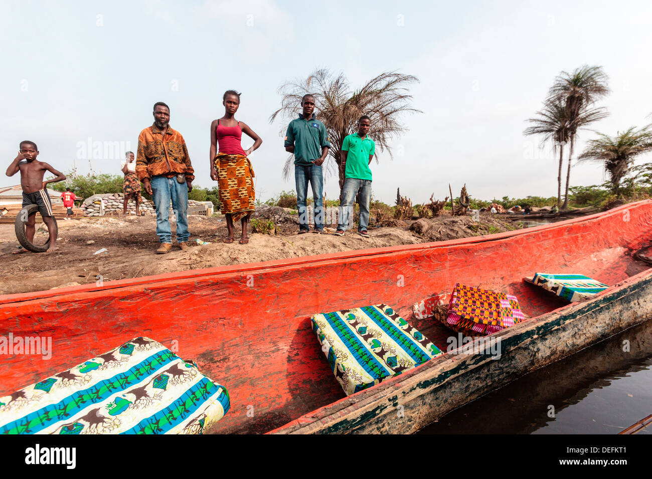 Africa, Liberia, Monrovia. People gathered by traditional pirogue boat ...