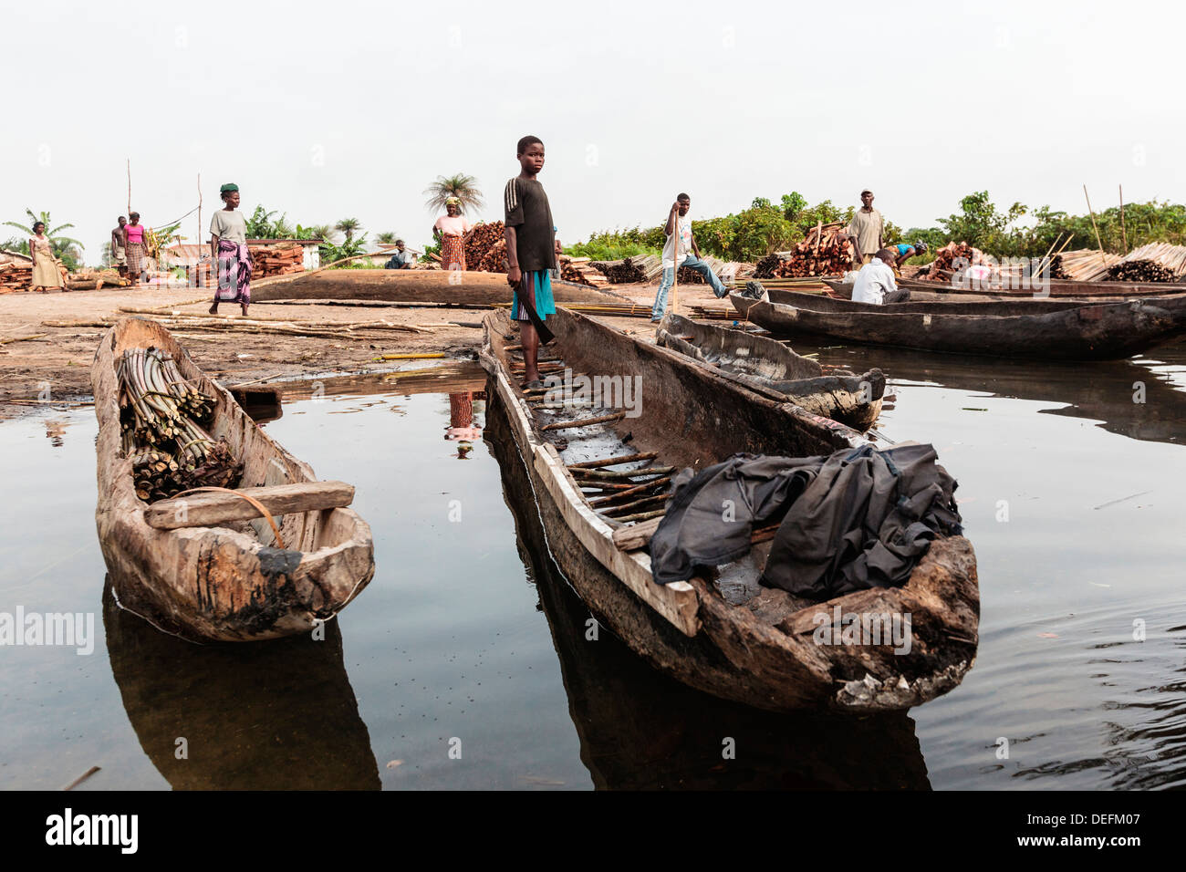 Africa, Liberia, Monrovia. People gathered by traditional pirogue boats ...
