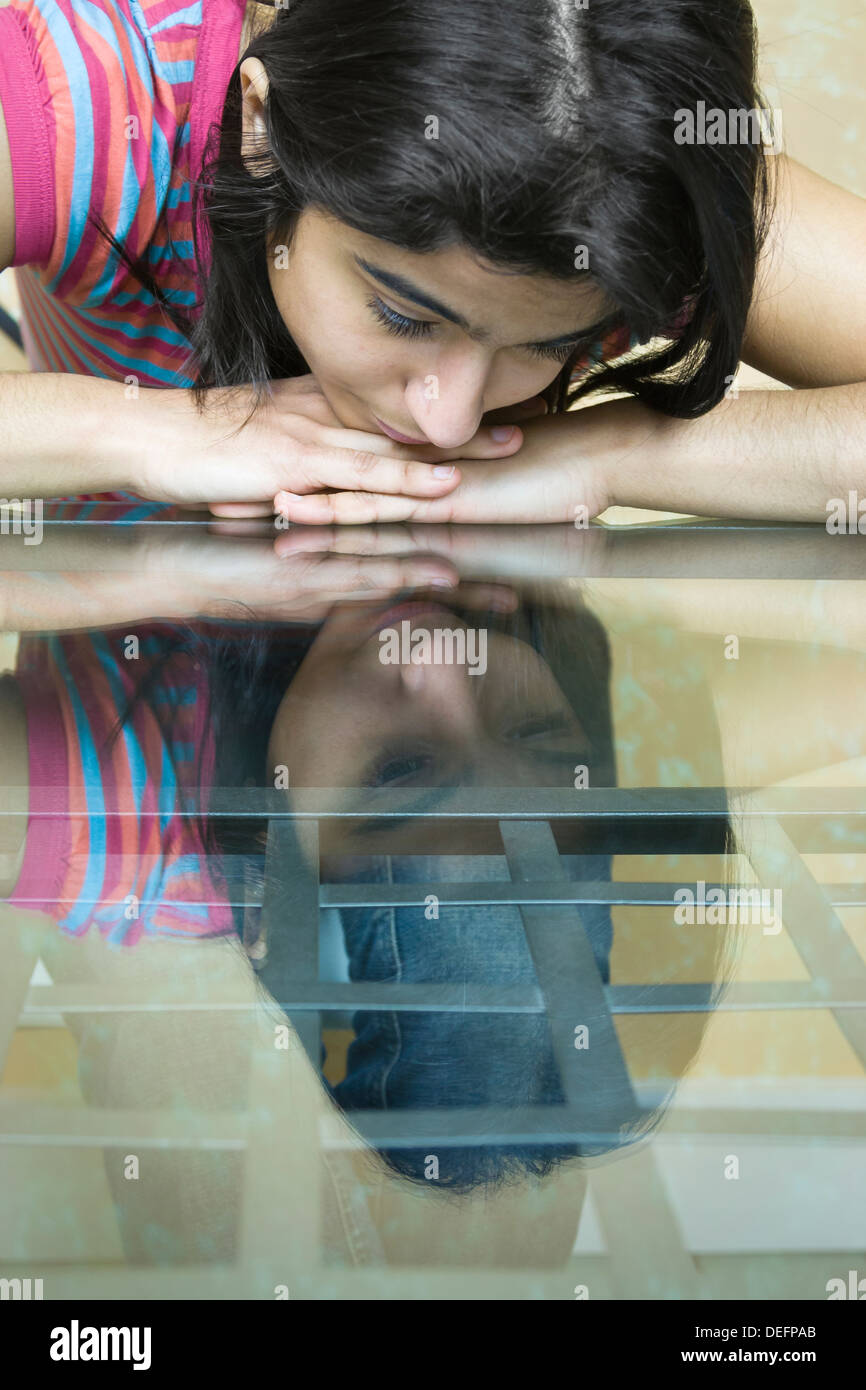 A young woman staring at her reflection Stock Photo - Alamy