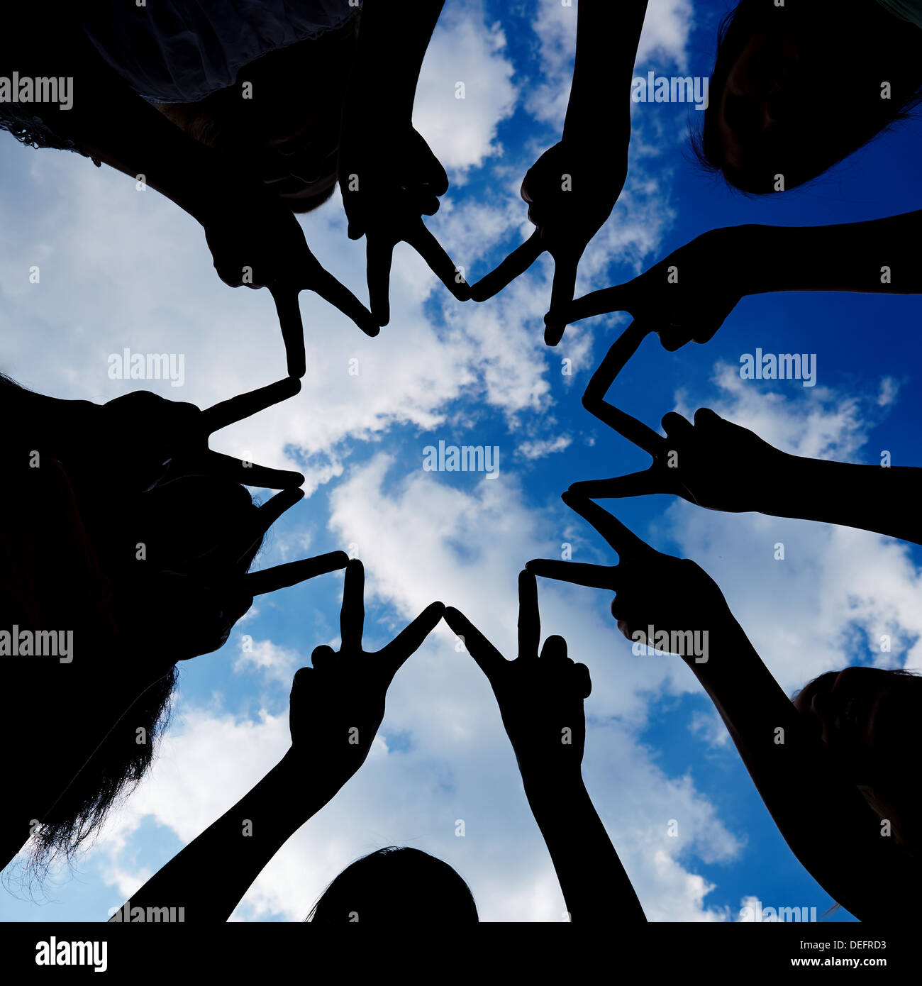 Silhouette of many hands forming star network under a sky Stock Photo ...