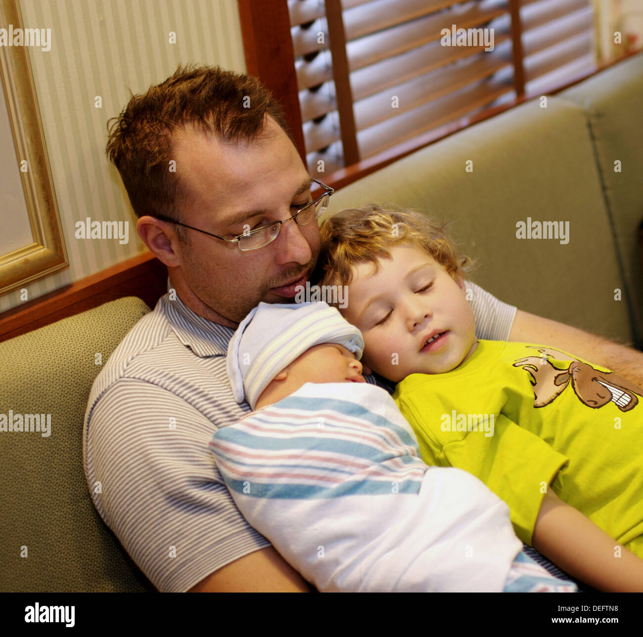 Father napping son on sofa hi-res stock photography and images - Alamy