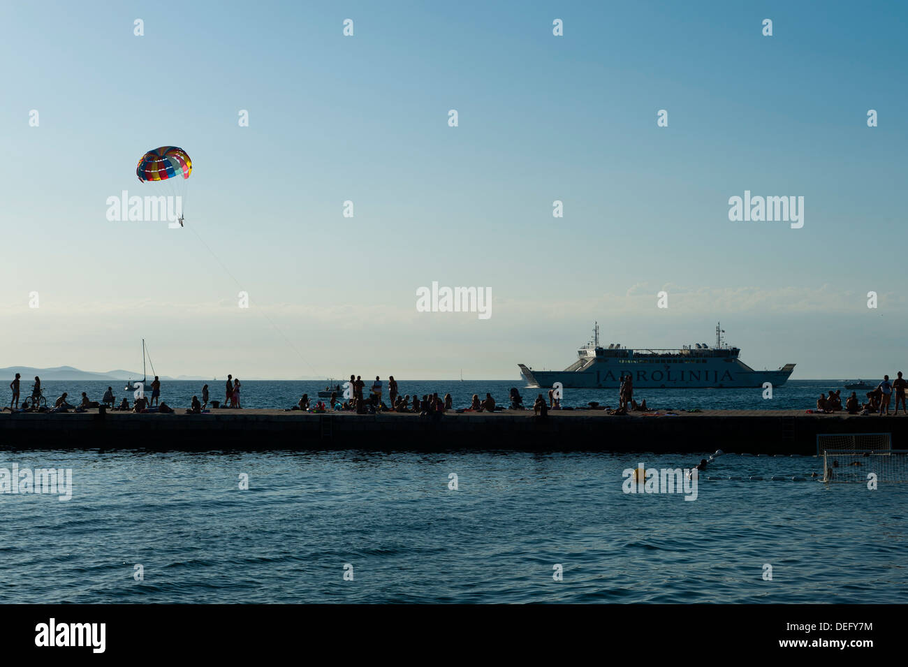 Sea parachute and bathers on a mole, City of Zadar, Zadar county ...