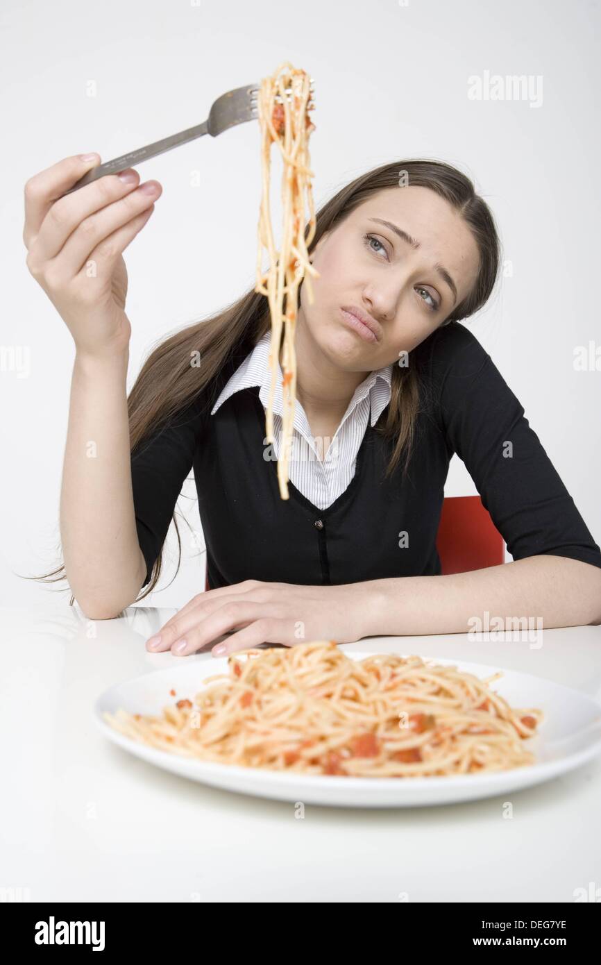 Woman eating noodle unhappy hi-res stock photography and images - Alamy