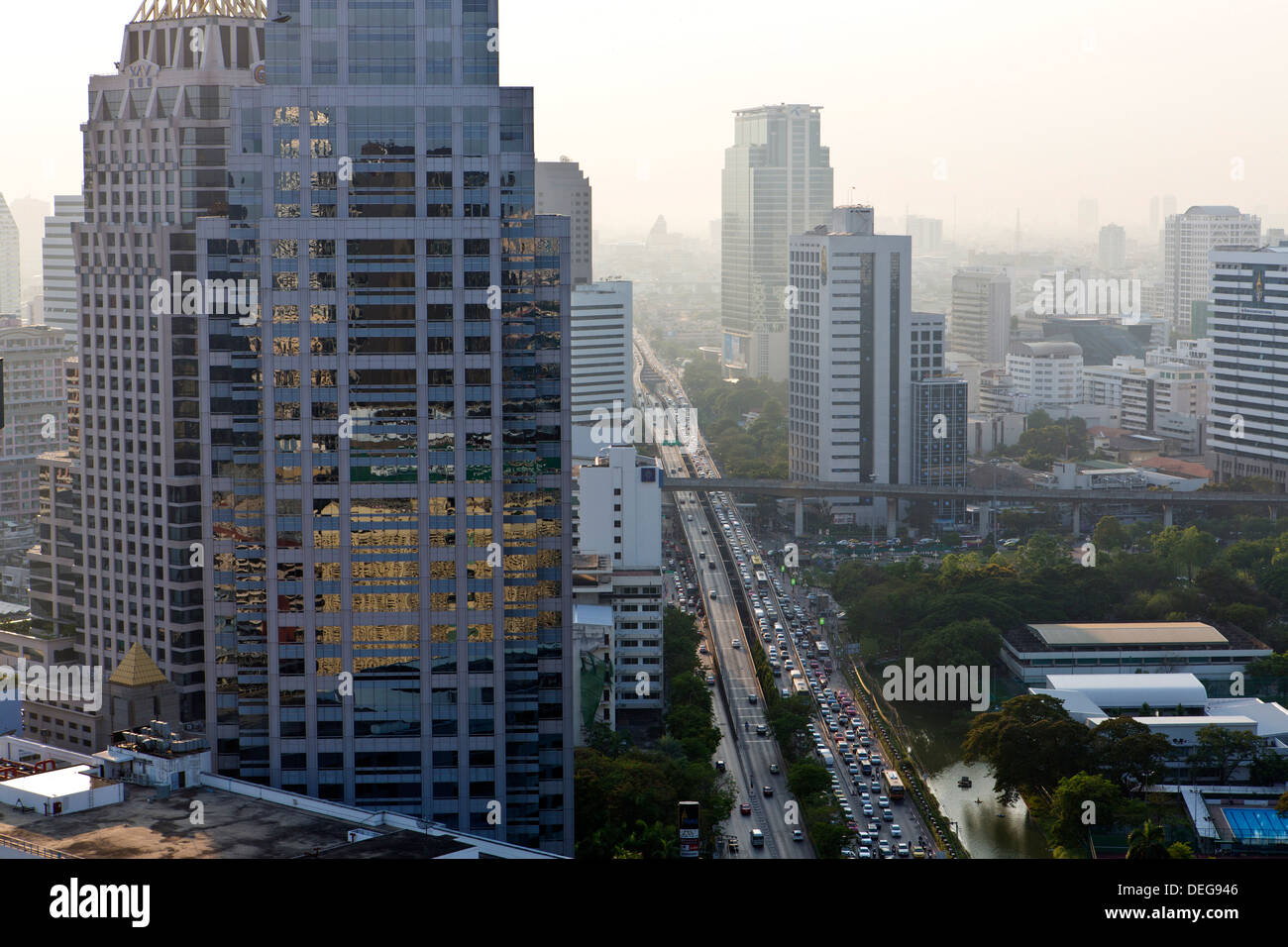 High rise buildings and traffic congestion on Rama IV in evening light ...
