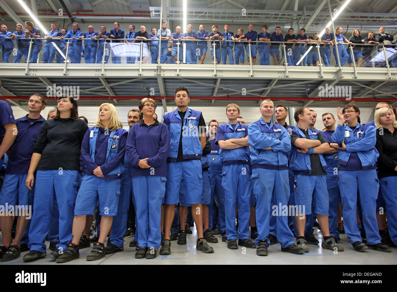 Employees of BMW celebrate the production launch of electric car i3 in ...