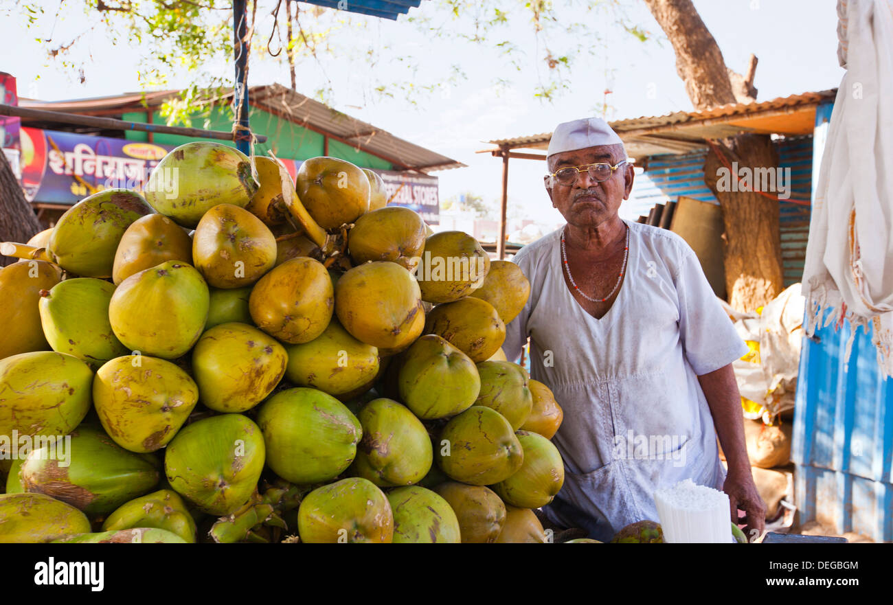 Man selling coconuts, Shani Shingnapur, Ahmednagar, Maharashtra, India ...