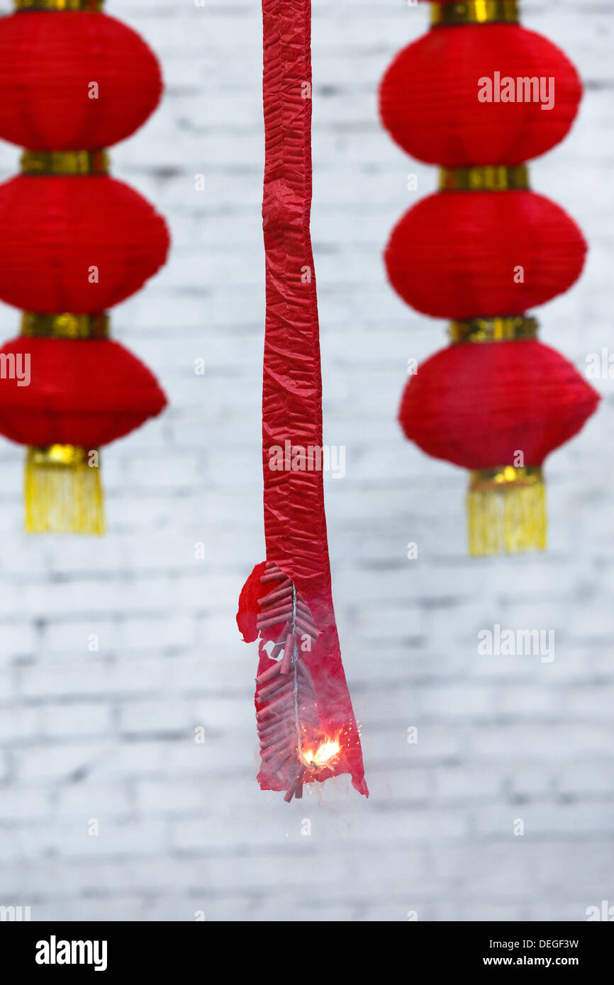 Burning firecrackers and red lanterns Stock Photo - Alamy