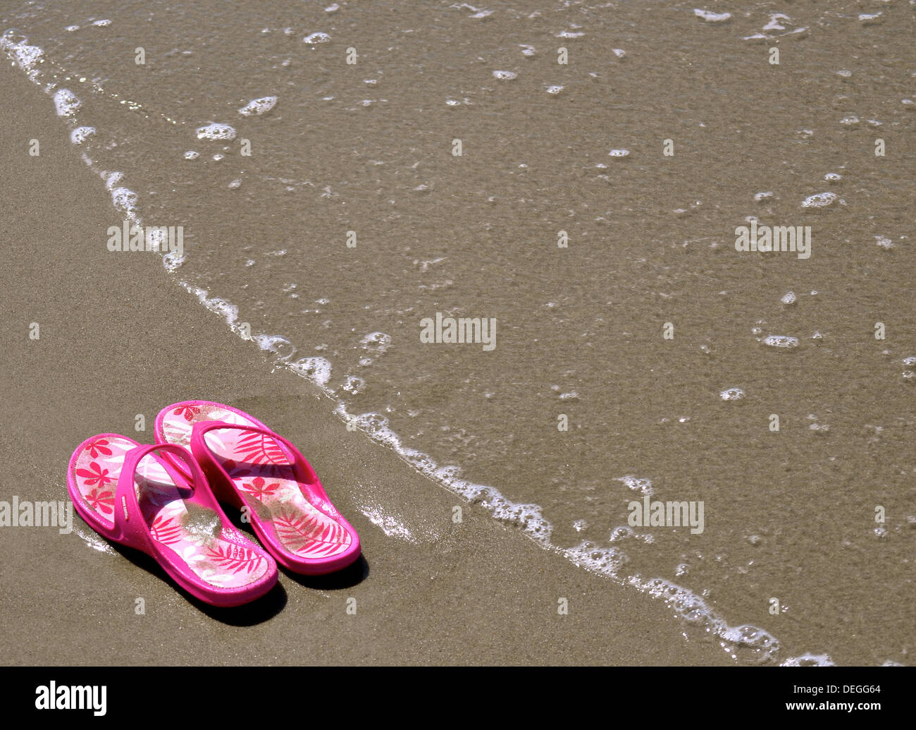 Flip Flops in the Sand Stock Photo - Alamy