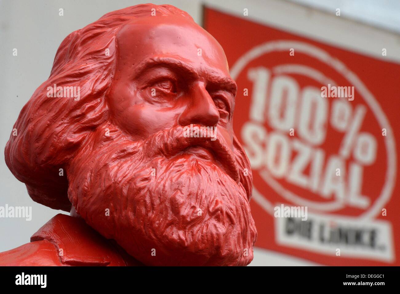A red sculpture of philosopher Karl Marx is visible at a campaign event ...