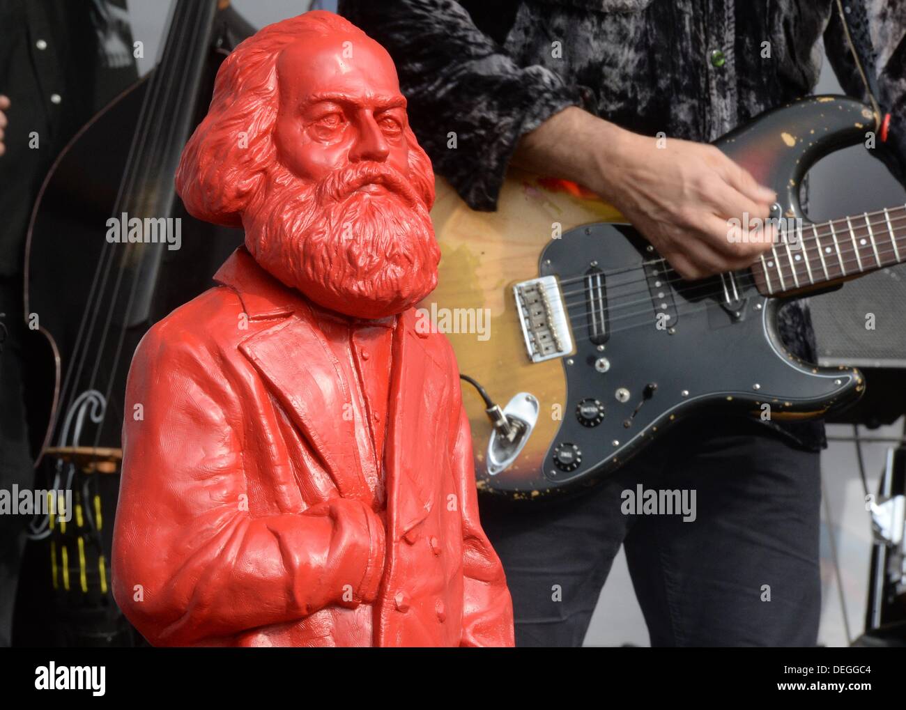 A red sculpture of philosopher Karl Marx is visible at a campaign event ...