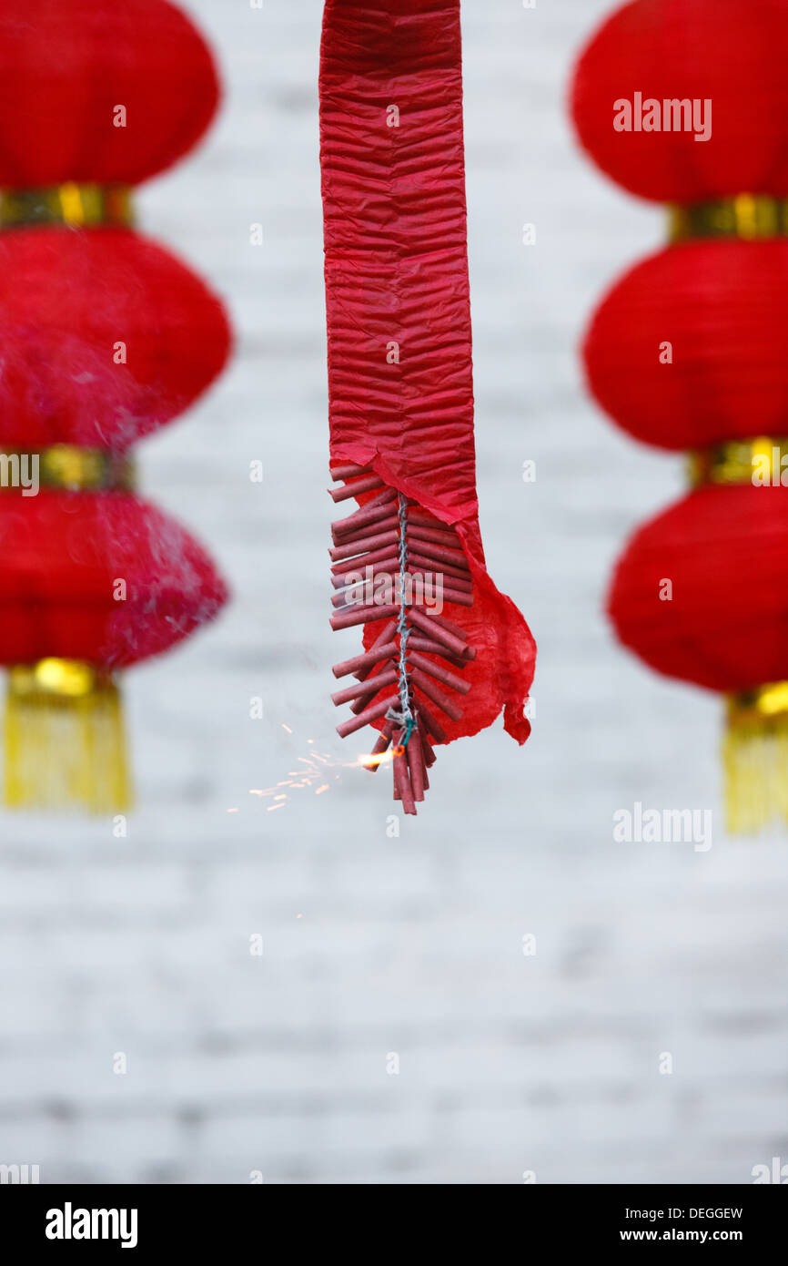 Burning firecrackers and red lanterns Stock Photo - Alamy