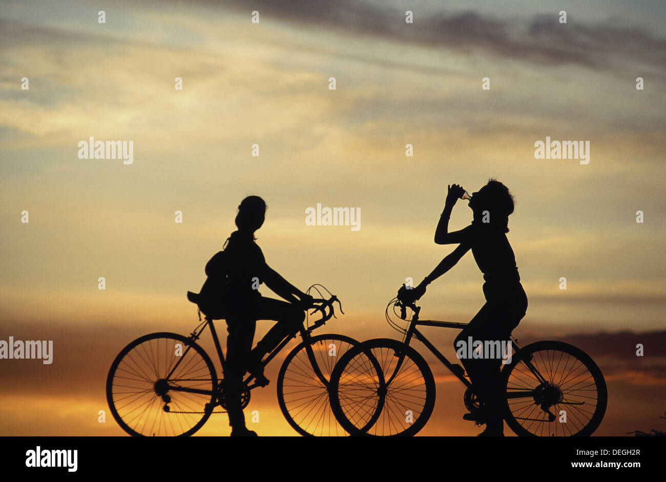 Girls ride bike sunset hi-res stock photography and images - Alamy