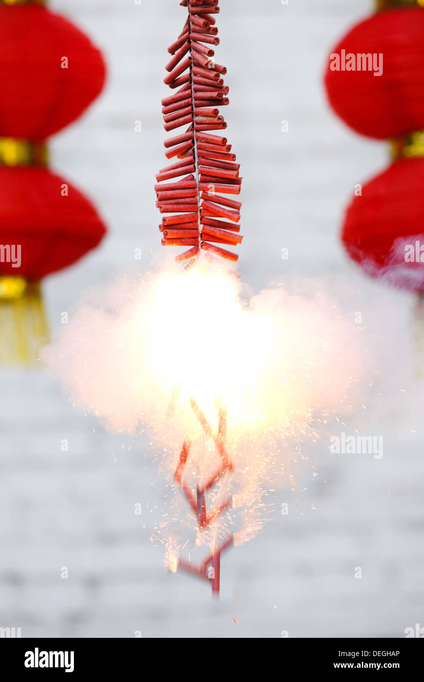 Burning firecrackers and red lanterns Stock Photo - Alamy