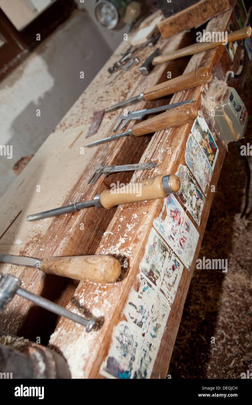 Furniture workshop tools and religious Saints prints glued to working ...