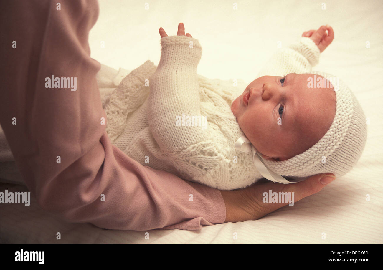 how to pick up a young baby Stock Photo - Alamy